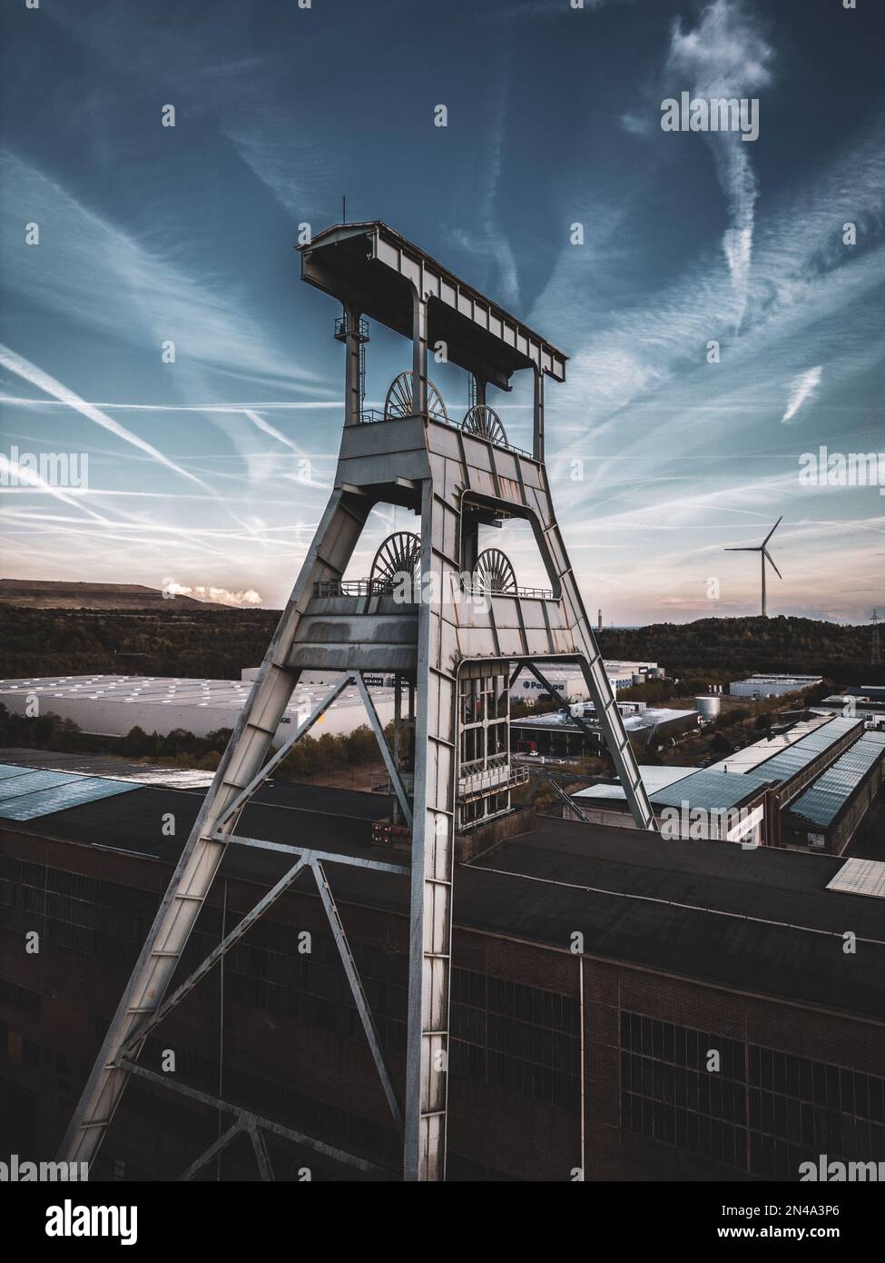 A vertical shot of a coal mine tower in a town under the blue sky Stock ...