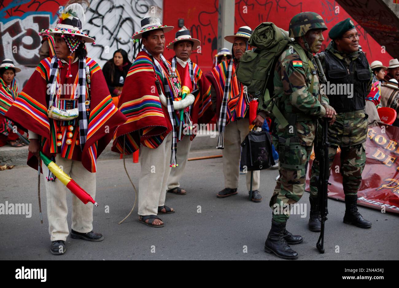 Quechua men and Bolivian Army soldiers wait for the start of a military ...