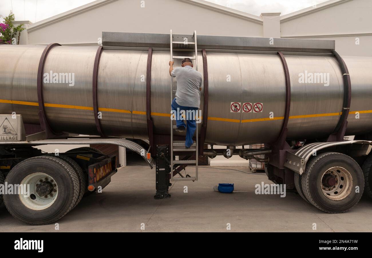 Robertson, Western Cape, South Africa. 2023. Tanker driver climbing ...