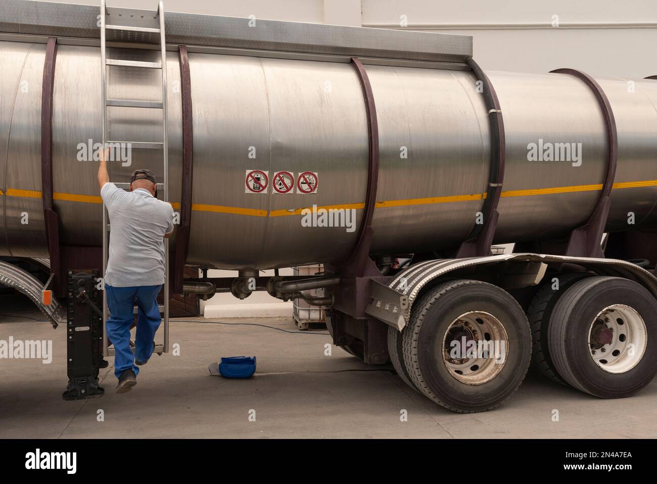 Robertson, Western Cape, South Africa. 2023. Tanker driver climbing ...
