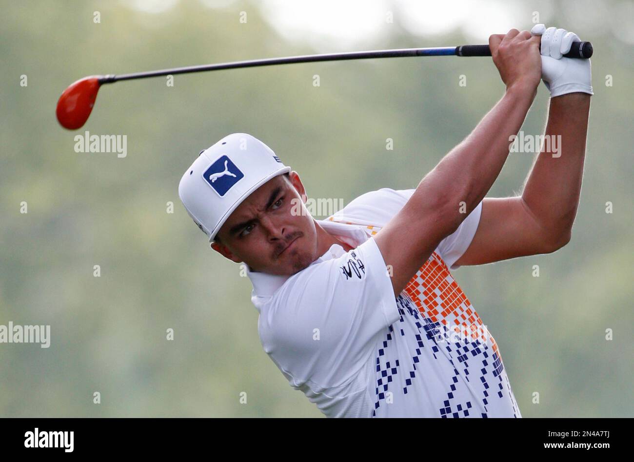 Rickie Fowler watches his tee shot on the first hole during the first ...