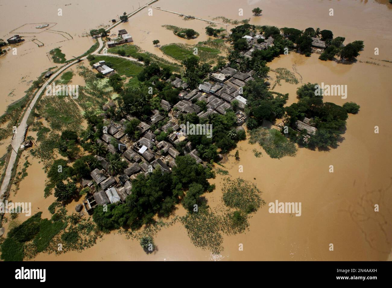 An aerial view shows villages partially submerged by monsoon floods in ...