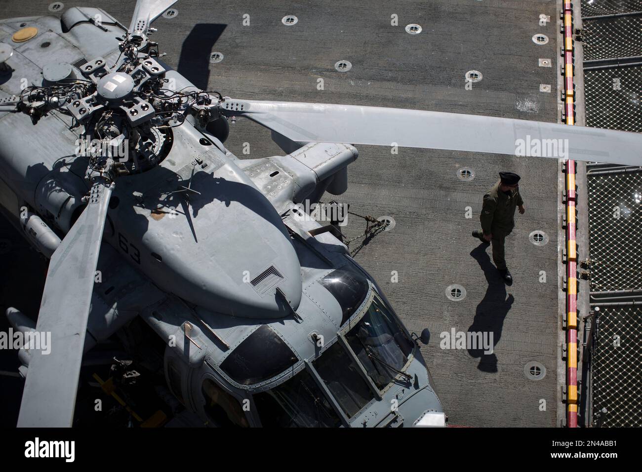 An MH-60S Seahawk helicopter sits aboard the U.S. Navy amphibious ...