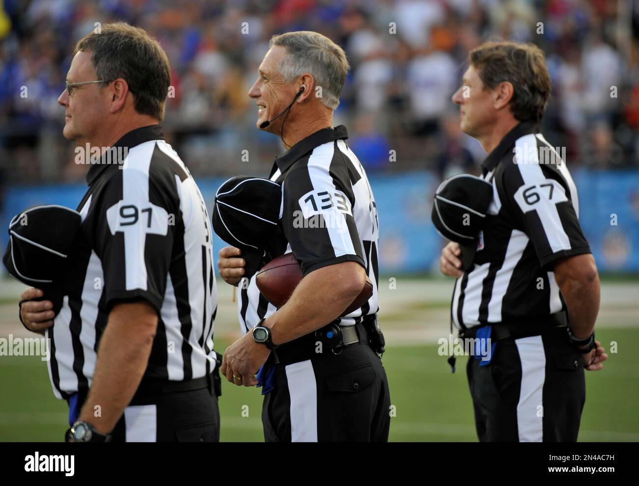Head linesman Jerry Bergman (91), back judge Steve Freeman (133) and ...