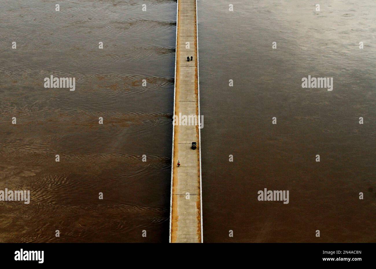 An aerial view shows commuters move through a bridge across the ...