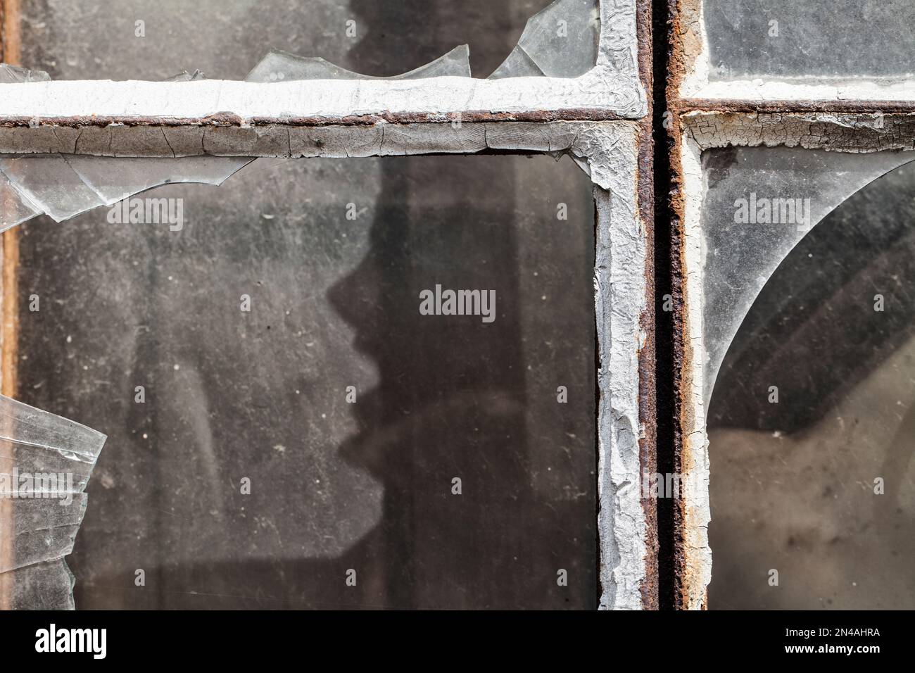 Broken window panes with a human-like screaming face Stock Photo - Alamy