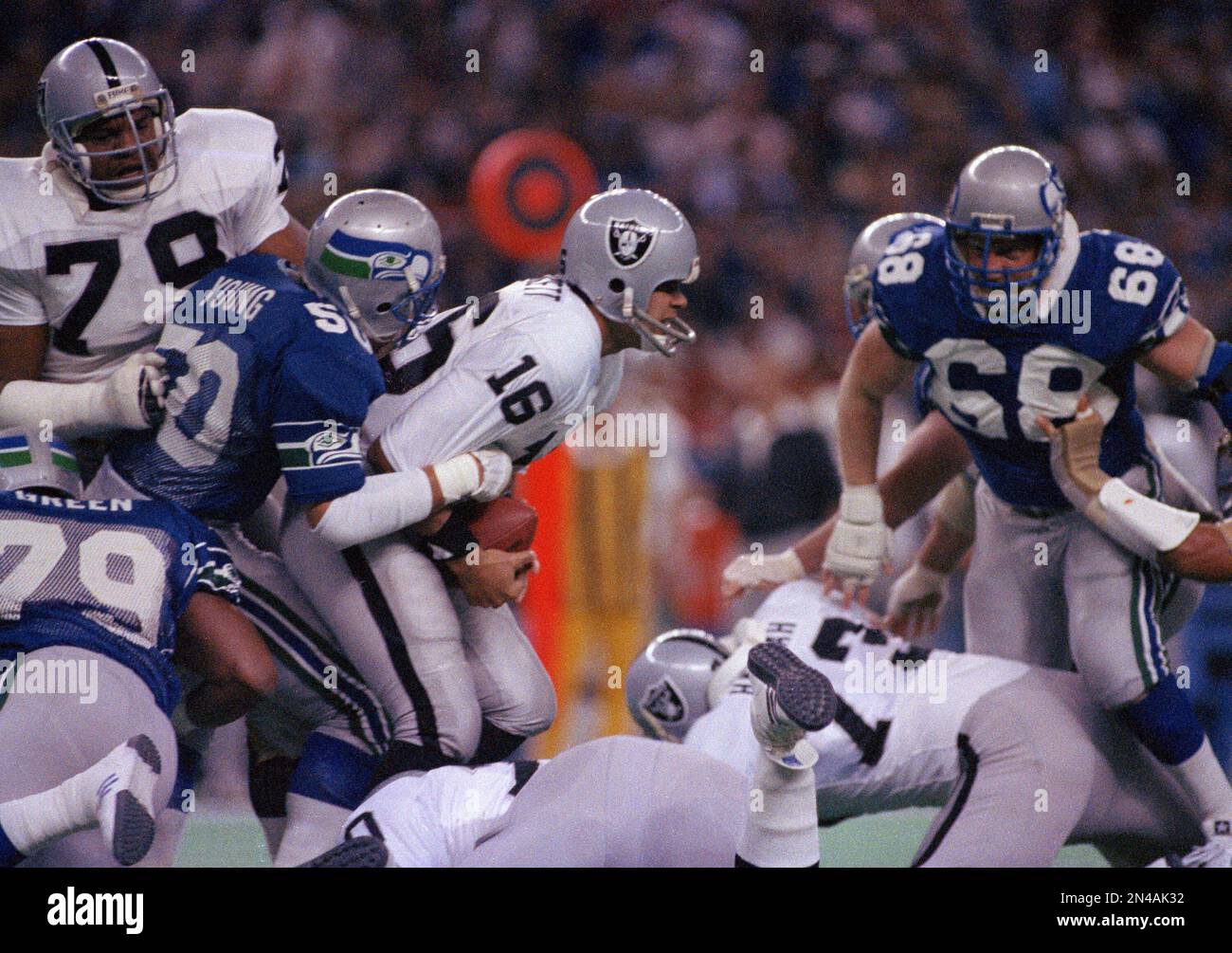Raiders quarterback Jim Plunkett (16) suffers a ten-yard sack at the ...