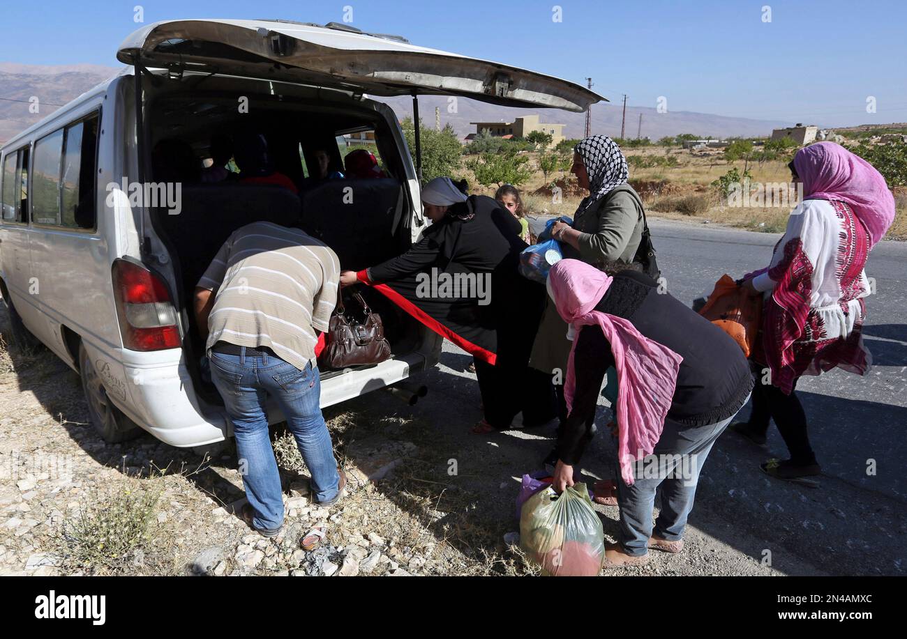 Lebanese citizens put their belongings in a minibus escaping from ...