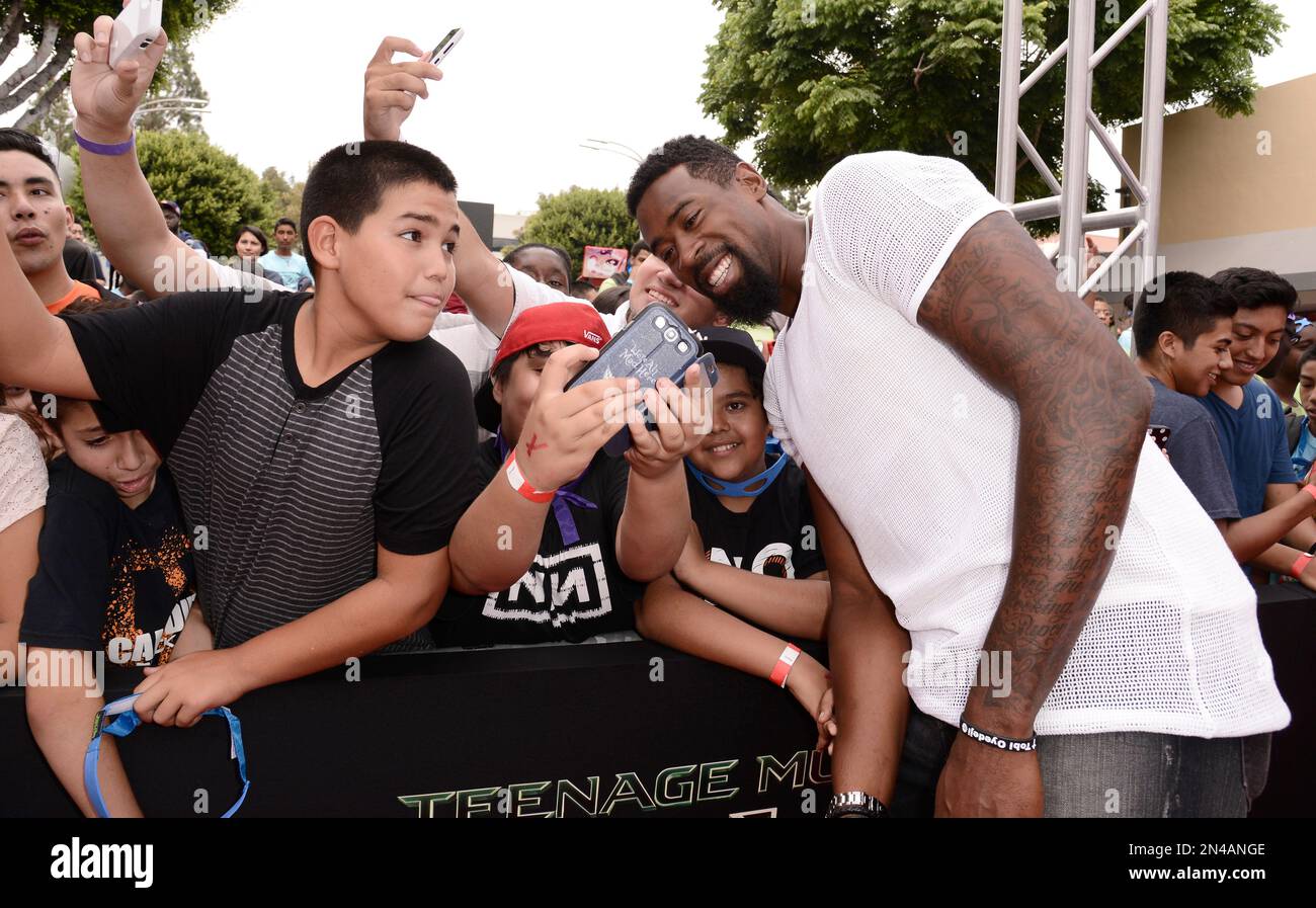 DeAndre Jordan poses for a photo with a fan at the Los Angeles premiere ...