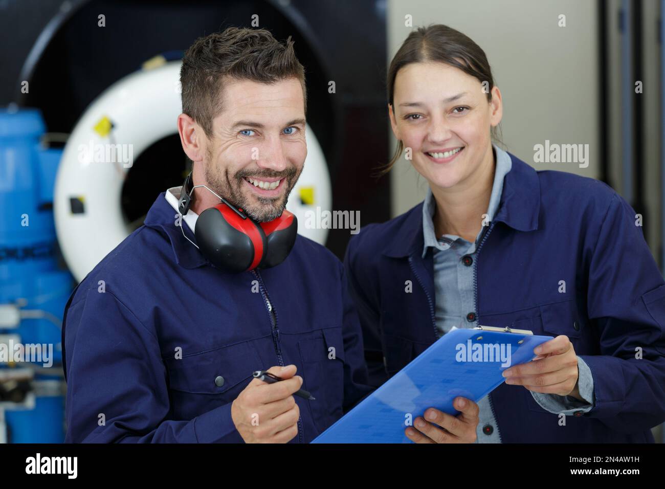 couple of positive work people laughing at the camera Stock Photo - Alamy