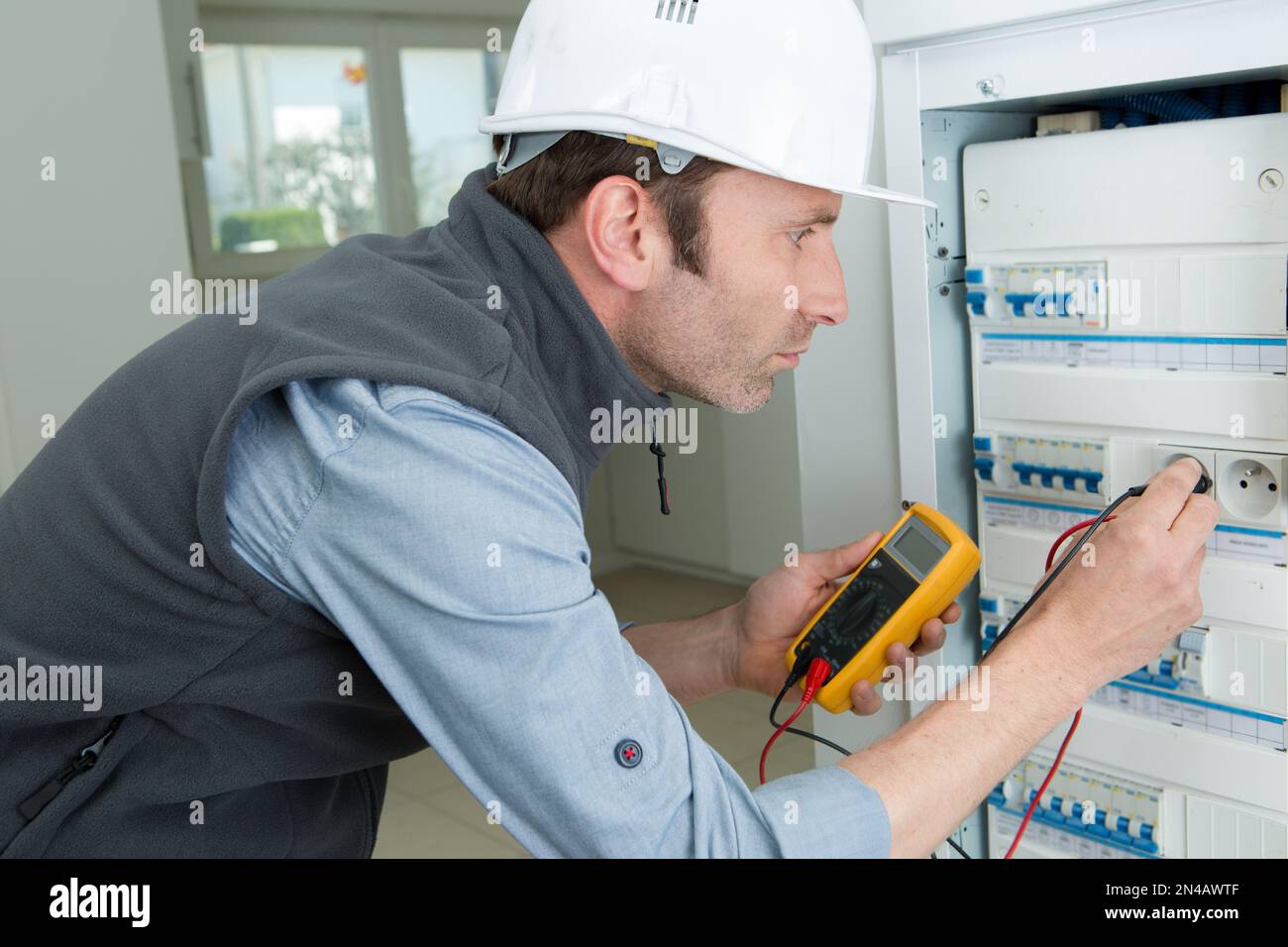 portrait of electrician inspecting live circuits Stock Photo - Alamy