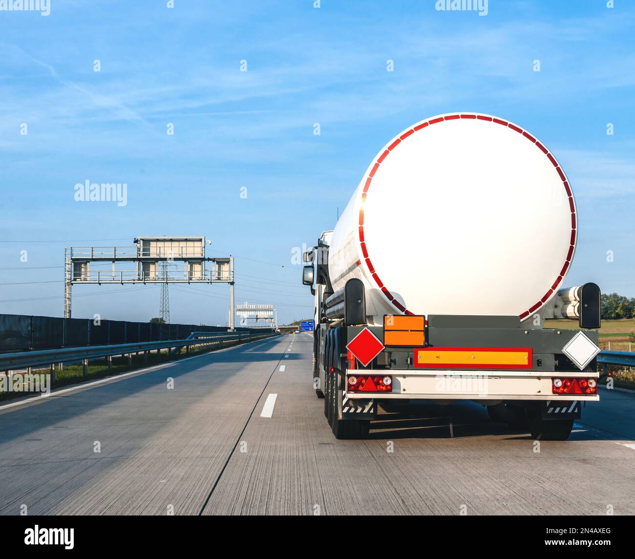 Rear side view of white cistern truck driving fast on Hugarian highway ...