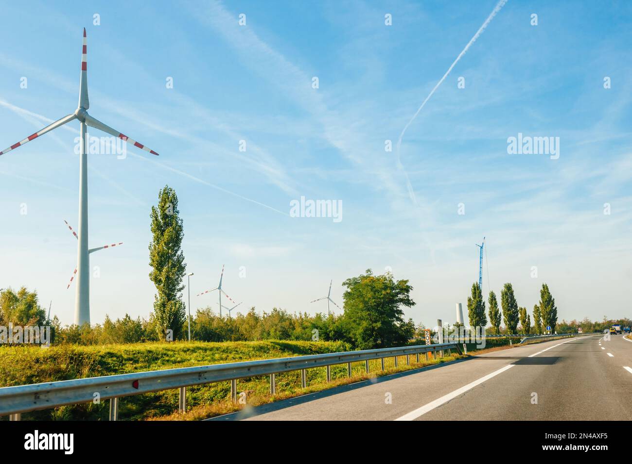 Modern large highway at large park of wind turbines producing ...