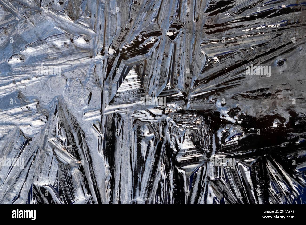 Shards of frozen water ice form patterns look black view from above ...
