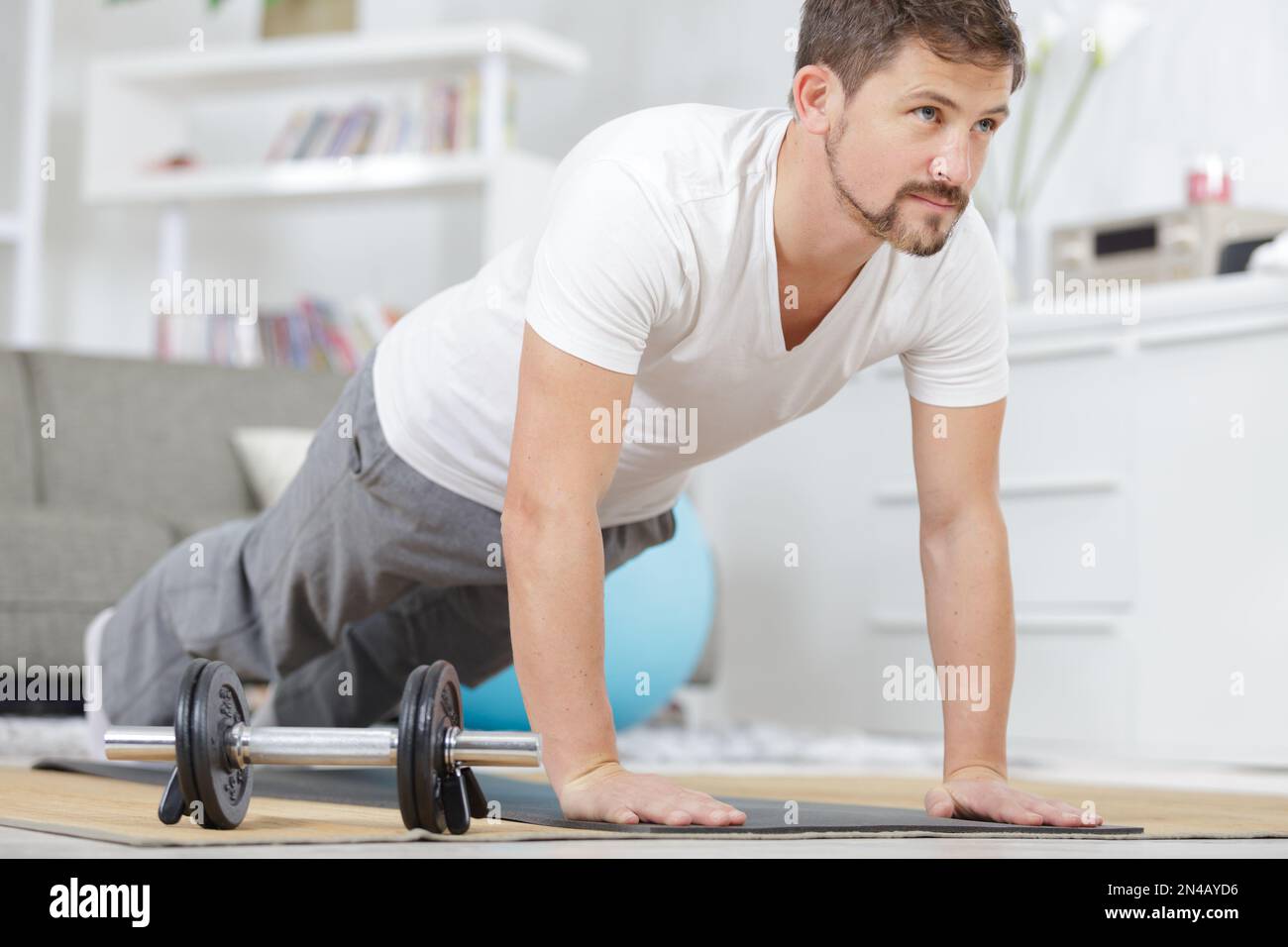 healthy gorgeous man doing an indoor side plank exercise Stock Photo ...