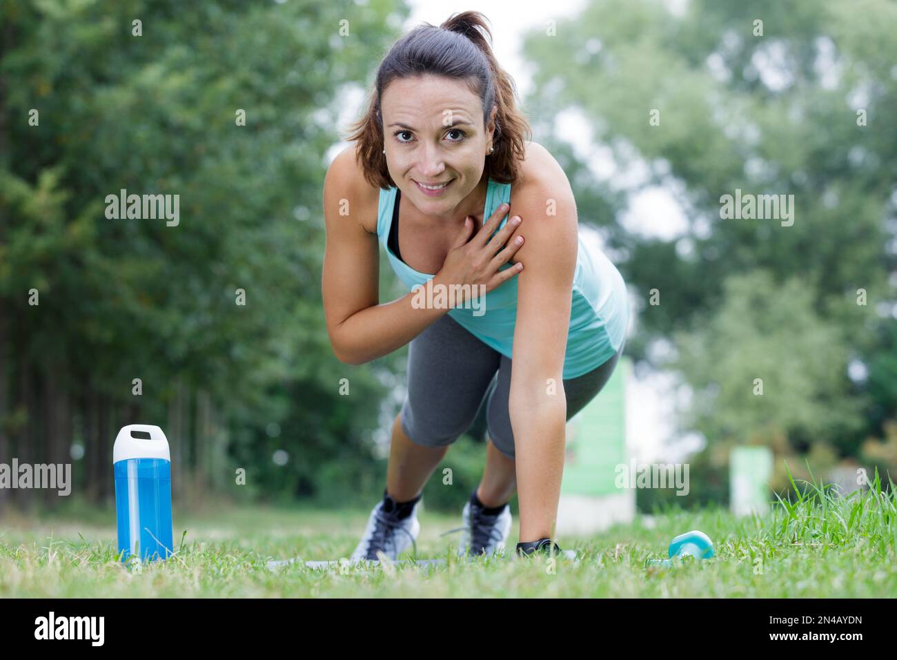 beautiful slim brunette doing some push-ups outside in park Stock Photo ...