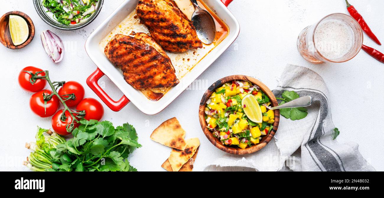 Spicy mango salsa sauce with red chili peppers, onion, garlic, lime and ...