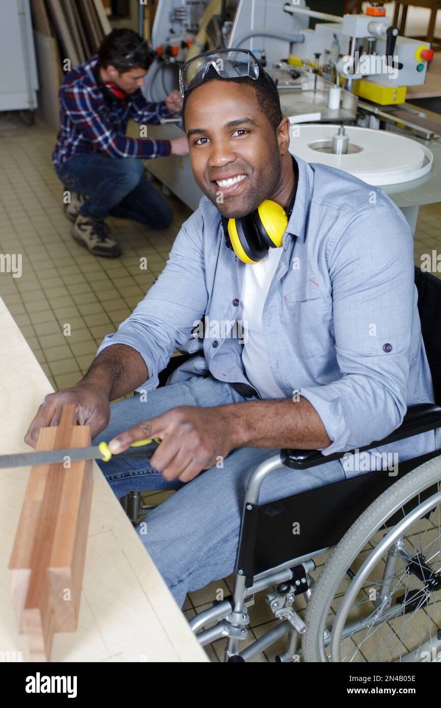 disabled male carpenter in woodworking workshop Stock Photo - Alamy