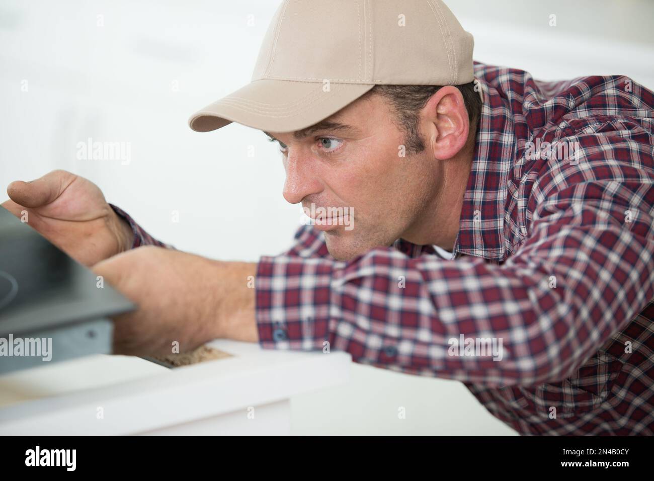 Handyman in uniform checking kitchen hi-res stock photography and ...