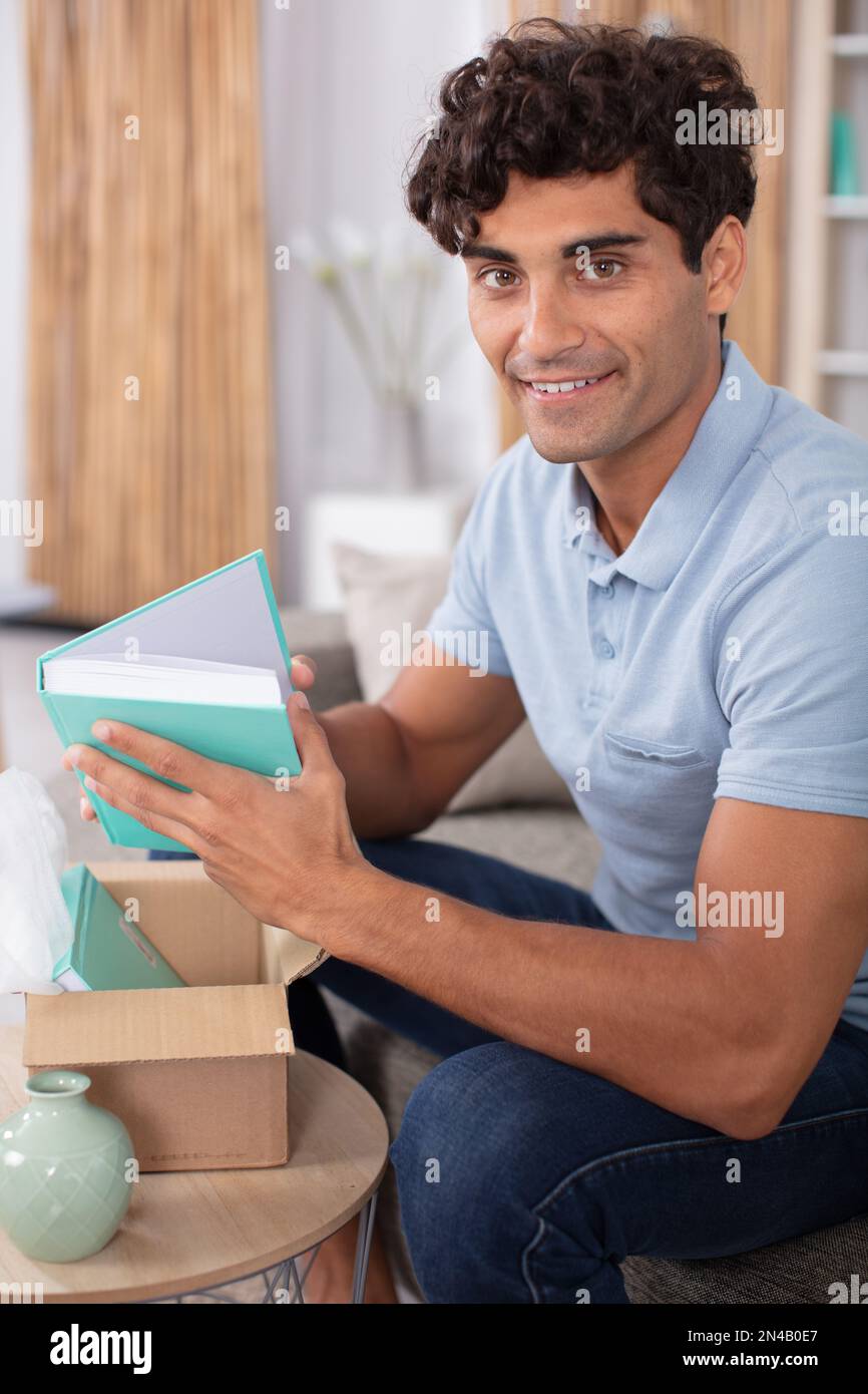 young man has received a delivery of books by courier Stock Photo - Alamy