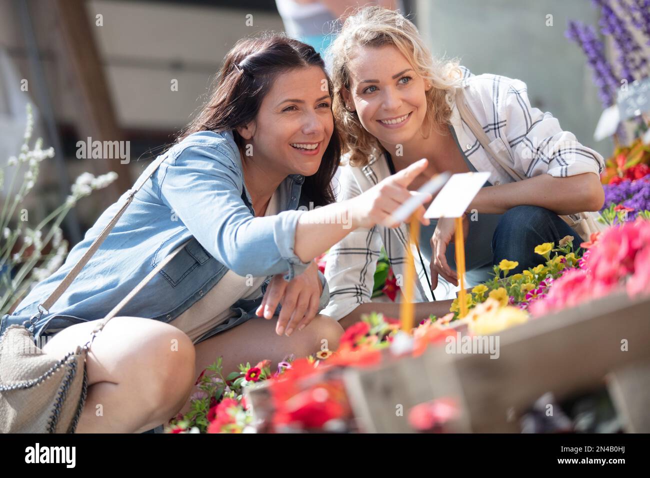 happy female friends shopping for flowers Stock Photo - Alamy