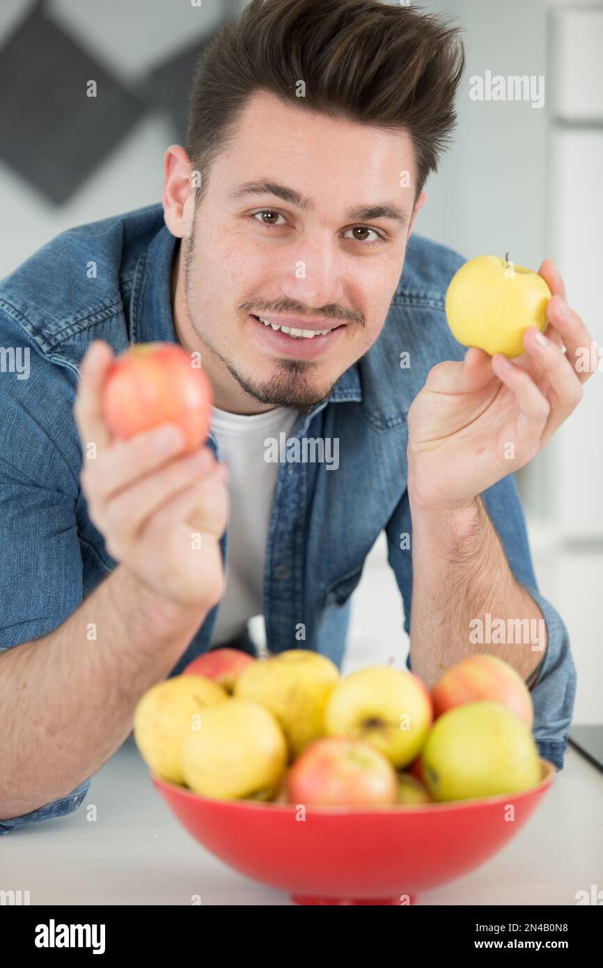 happy young man takes apples Stock Photo - Alamy