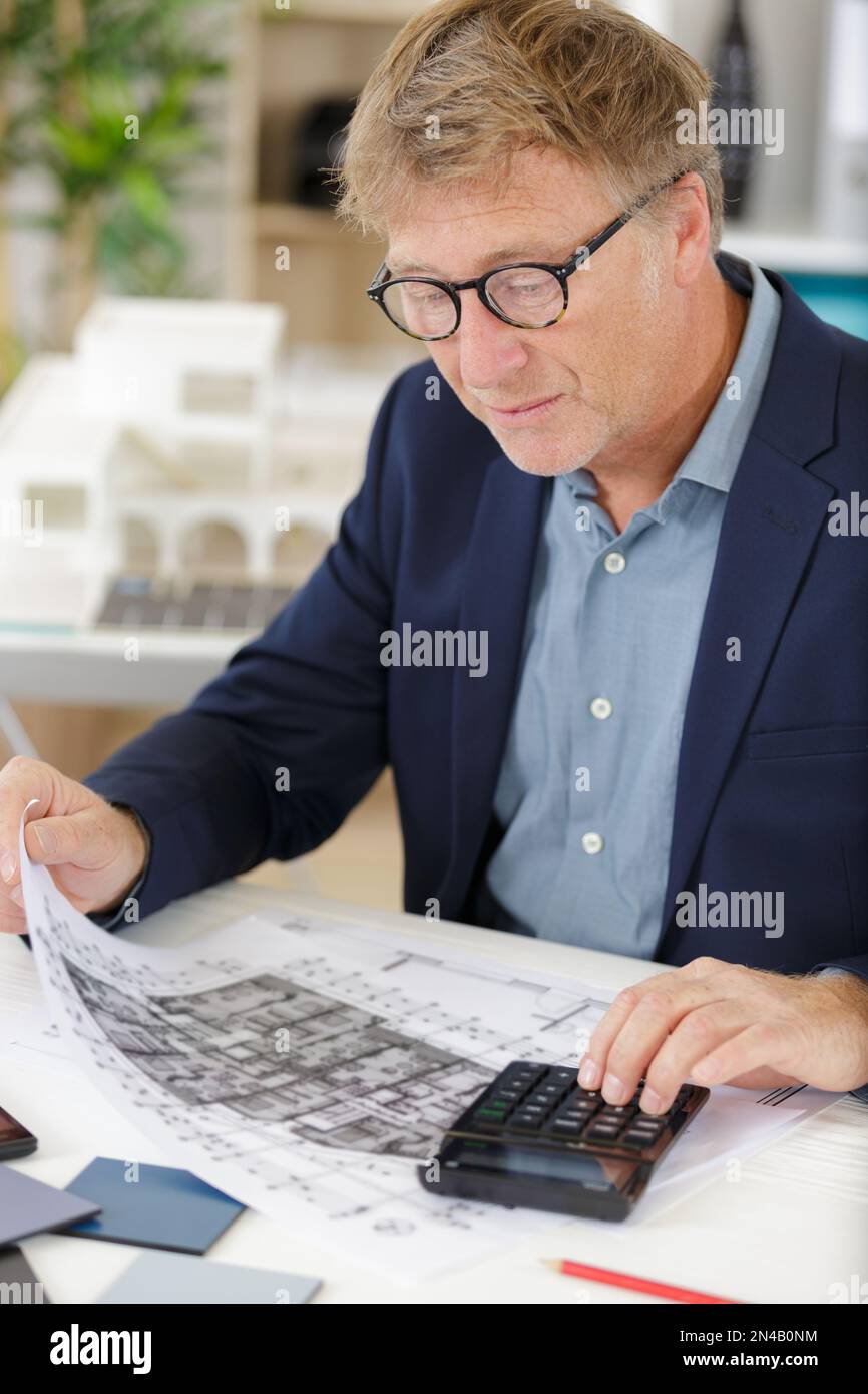 architect working on blueprint with blueprints Stock Photo - Alamy
