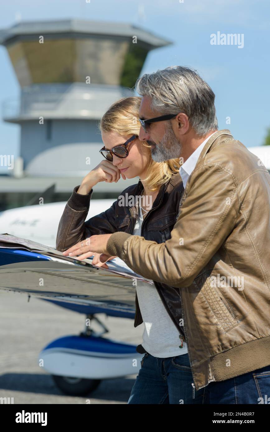 private plane pilot explaining the route to the client Stock Photo - Alamy