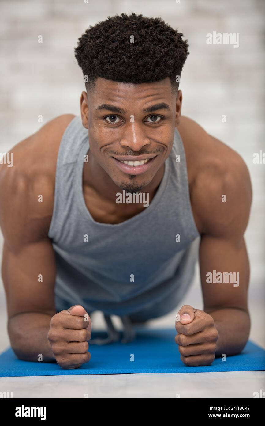 muscular man holding plank position Stock Photo - Alamy
