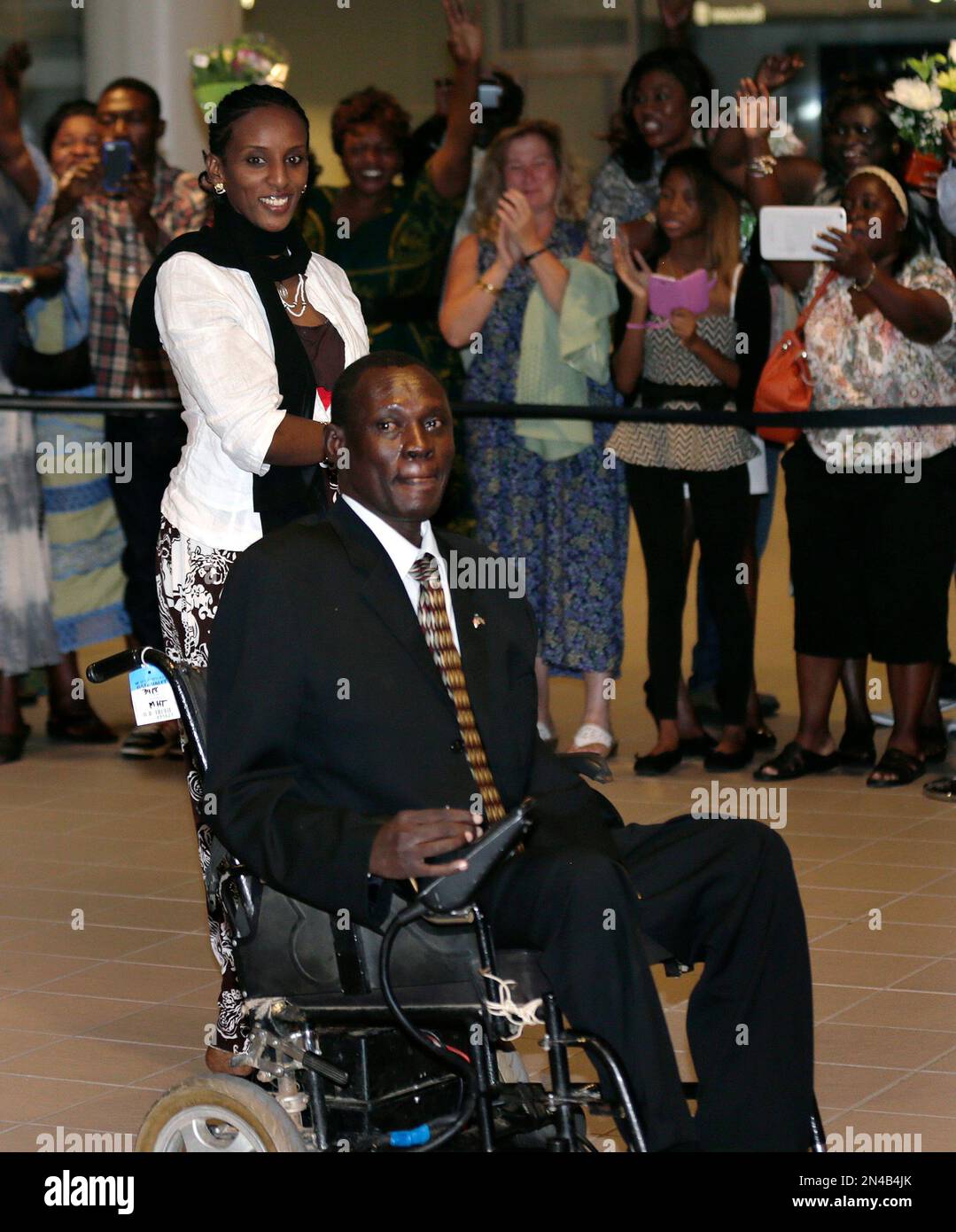 Meriam Ibrahim, left, and her husband Daniel Wani are greeted by family ...