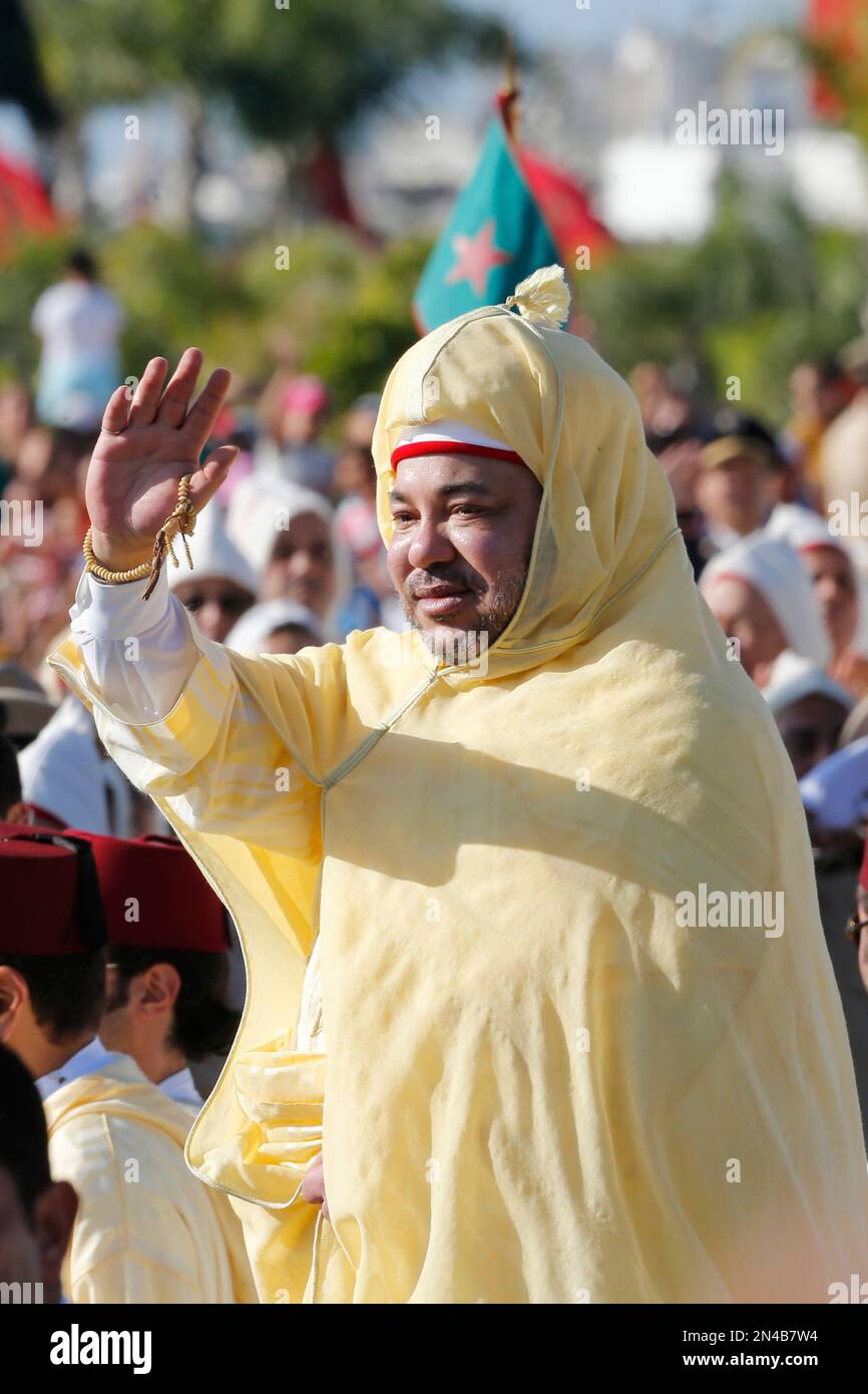 Morocco's King Mohammed VI waves to the crowd as he stands in a limousine during a ceremony of ...