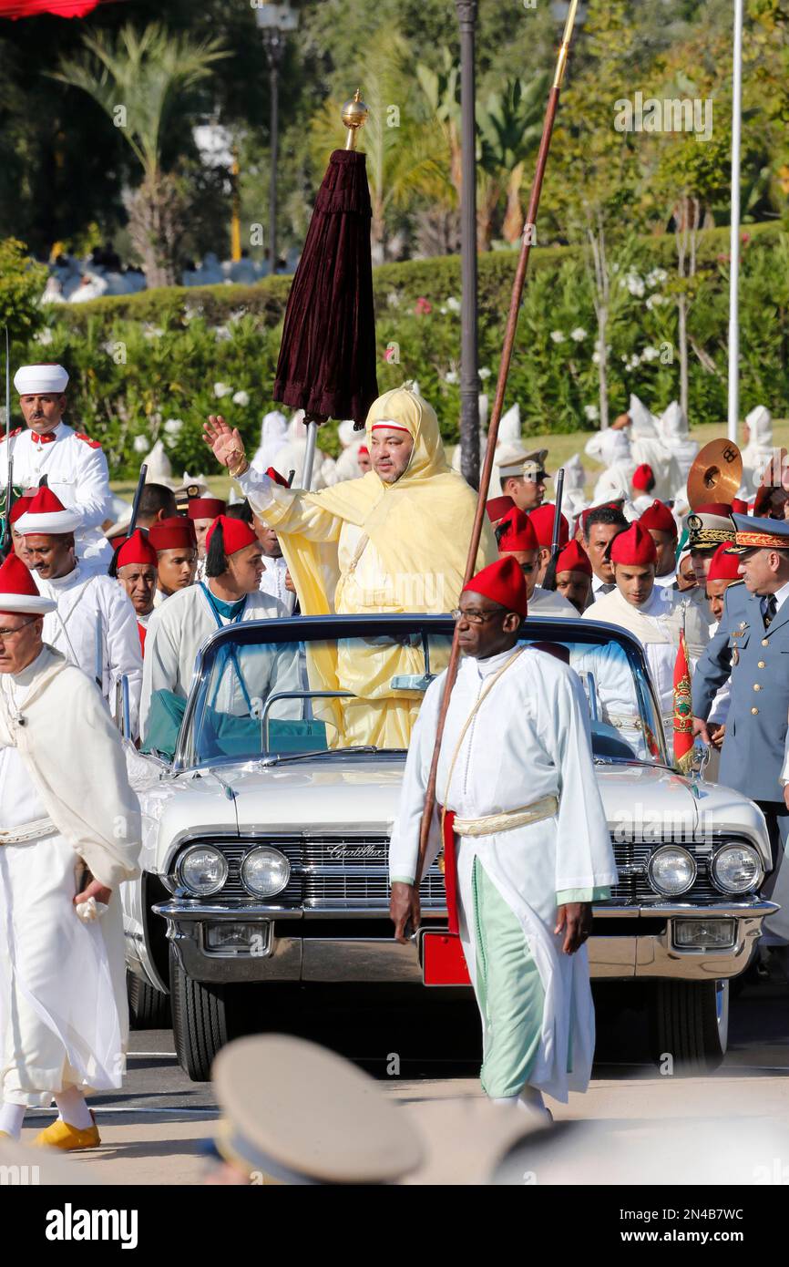 Morocco's King Mohammed VI waves to the crowd as he stands in a limousine during a ceremony of ...