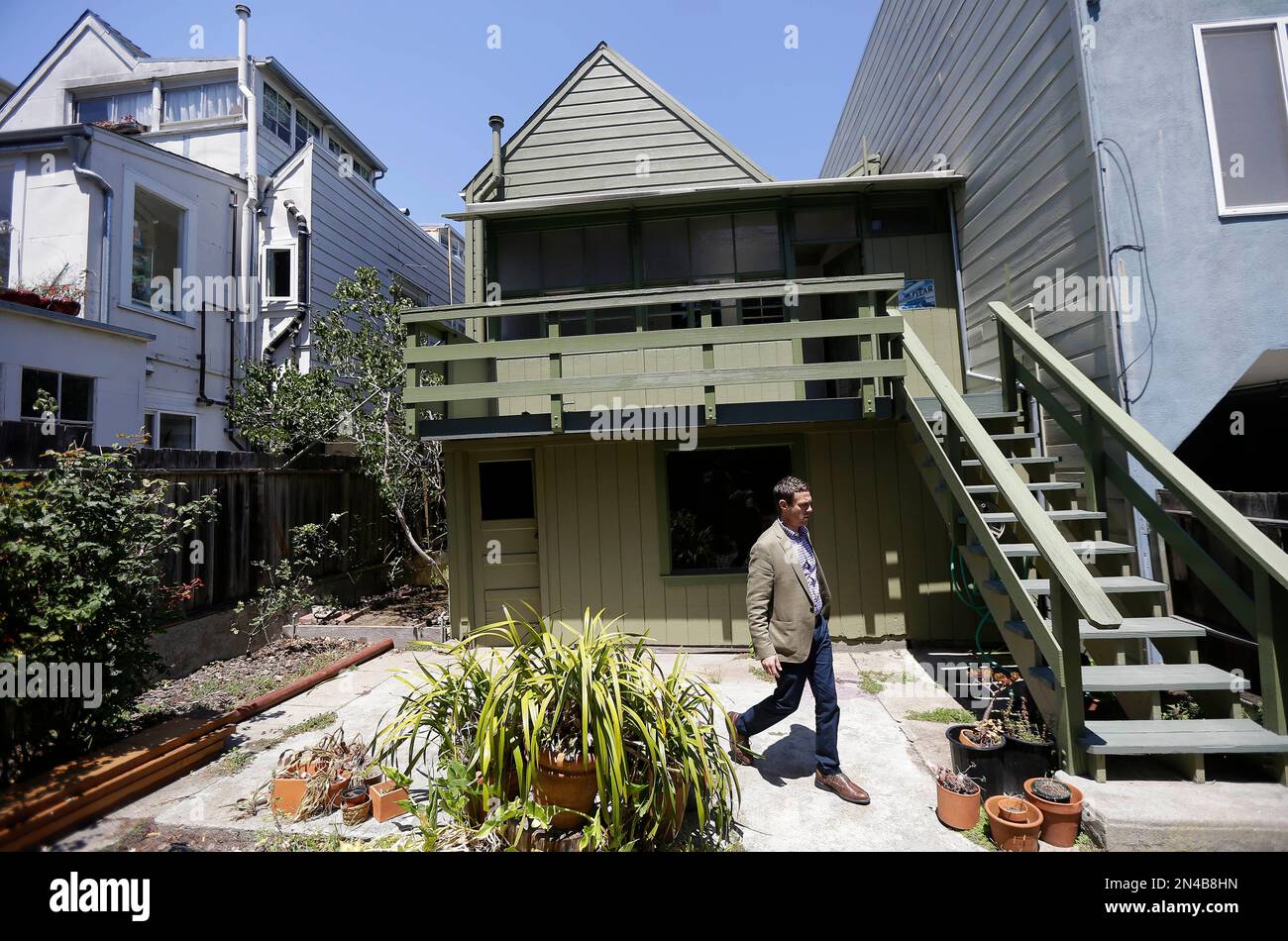 George Limperis, a realtor with Paragon Real Estate Group, walks in the ...