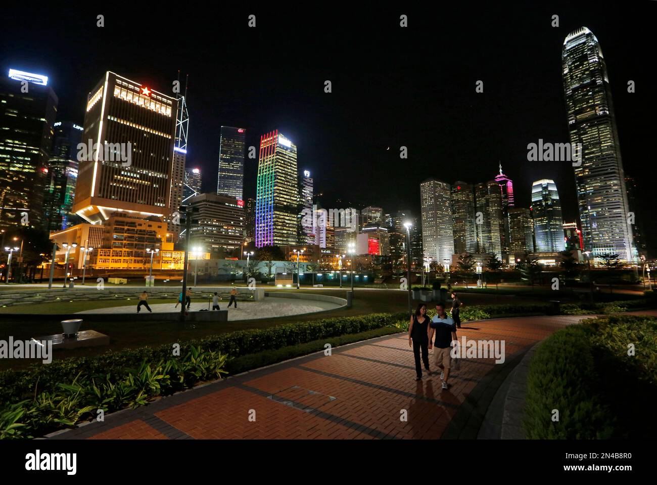 High-rise commercial buildings are lit up at night in Hong Kong ...