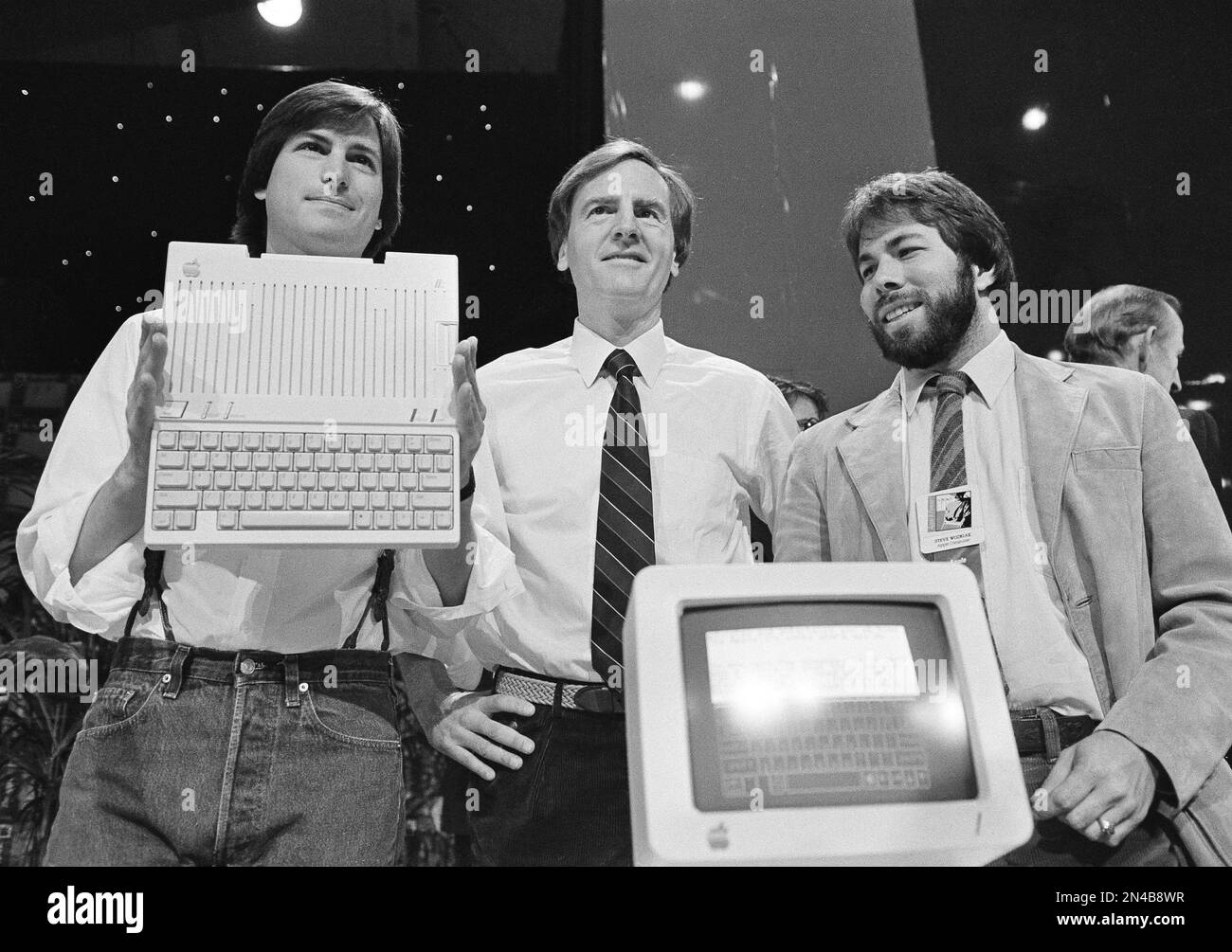 Steve Jobs, left, chairman of Apple Computers, John Sculley, center ...