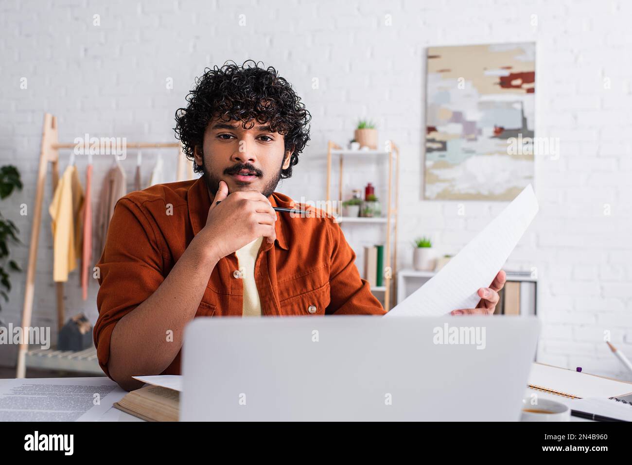 Person paper looking laptop hi-res stock photography and images - Alamy