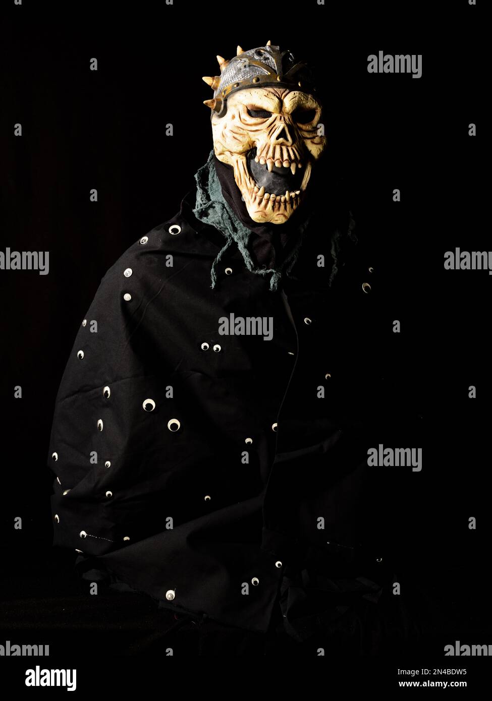 A scary ghoul mask with a cape of googly eyes for Halloween Stock Photo ...