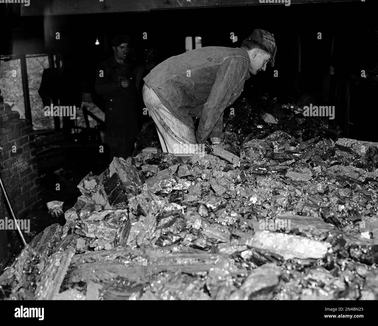 A miner is shown loading a car of coal in the Brookside mine in Ages ...