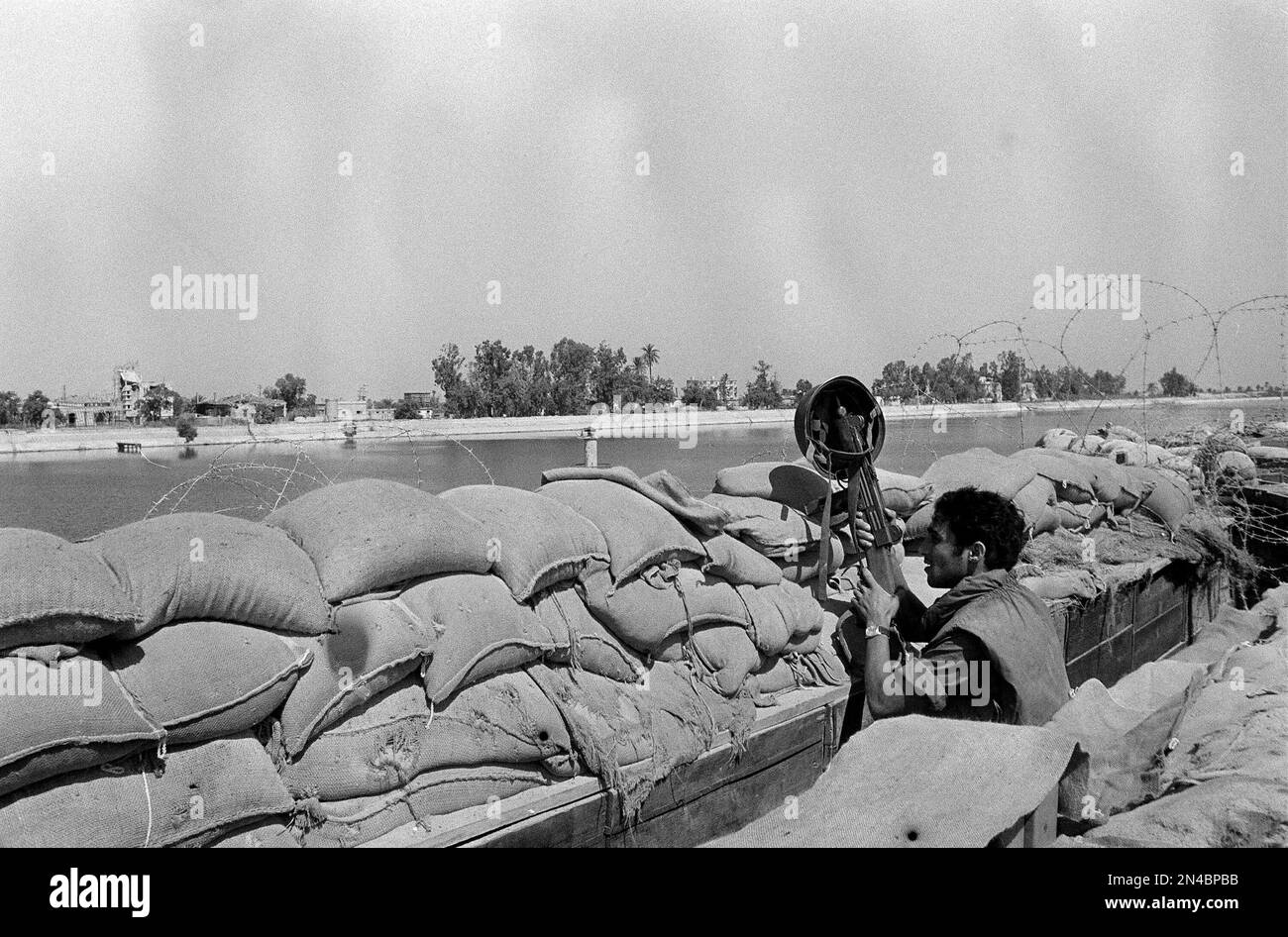 An Israeli soldier takes no chances as he tests the intentions of his ...