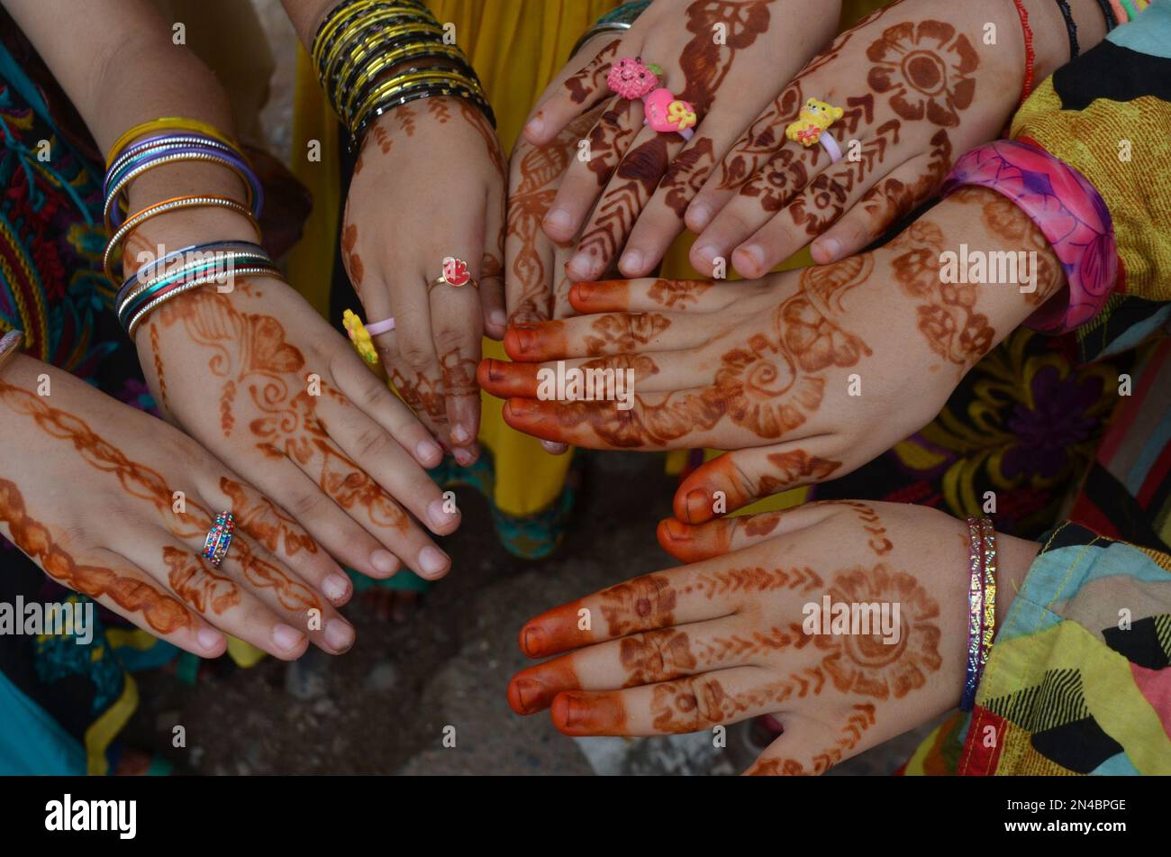 Pakistani girls show their hands painted with henna ahead of the Muslim ...