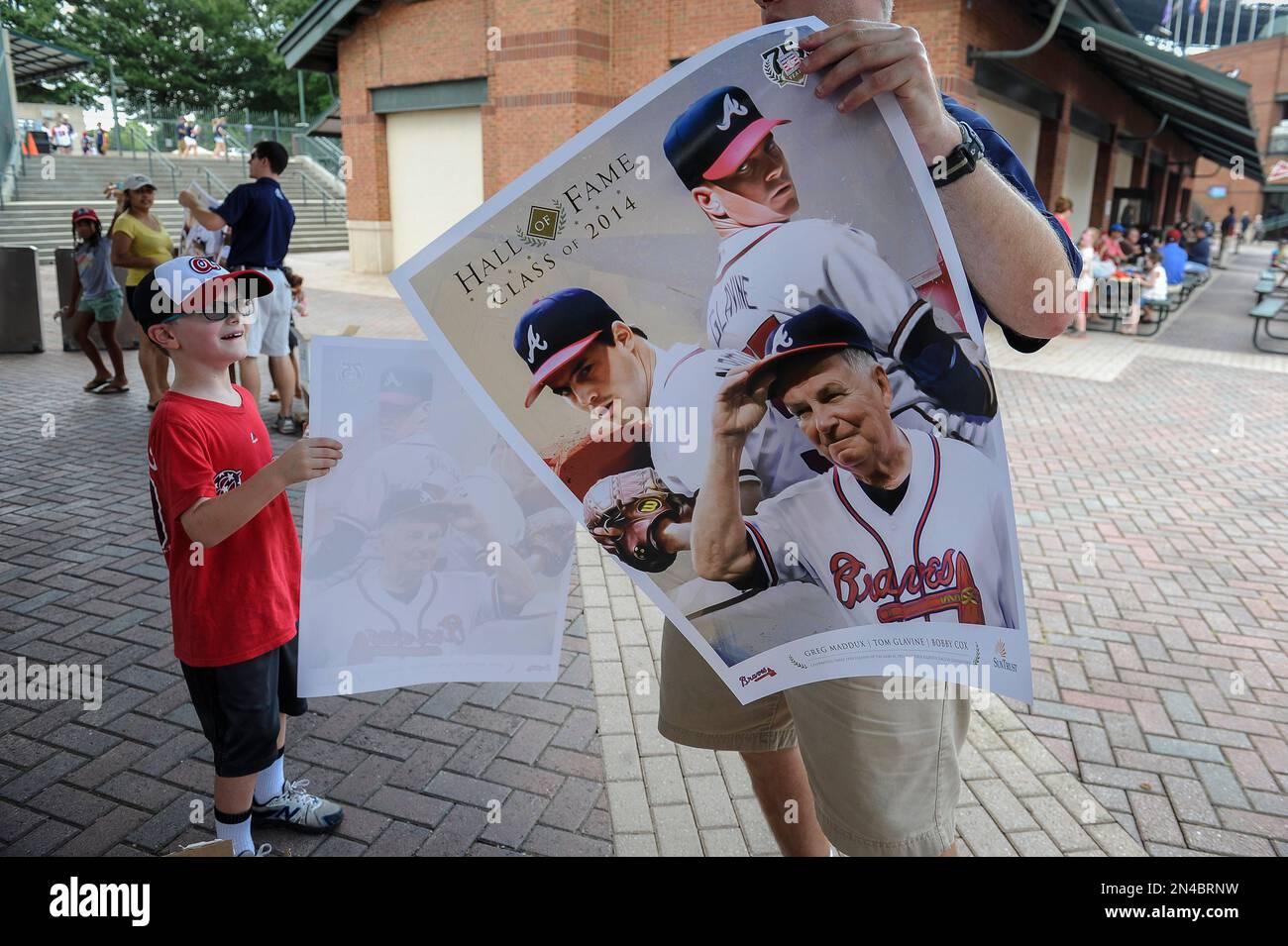 Young fan Charlie Stuart, 6, of Savannah, Ga., accepts a poster being ...