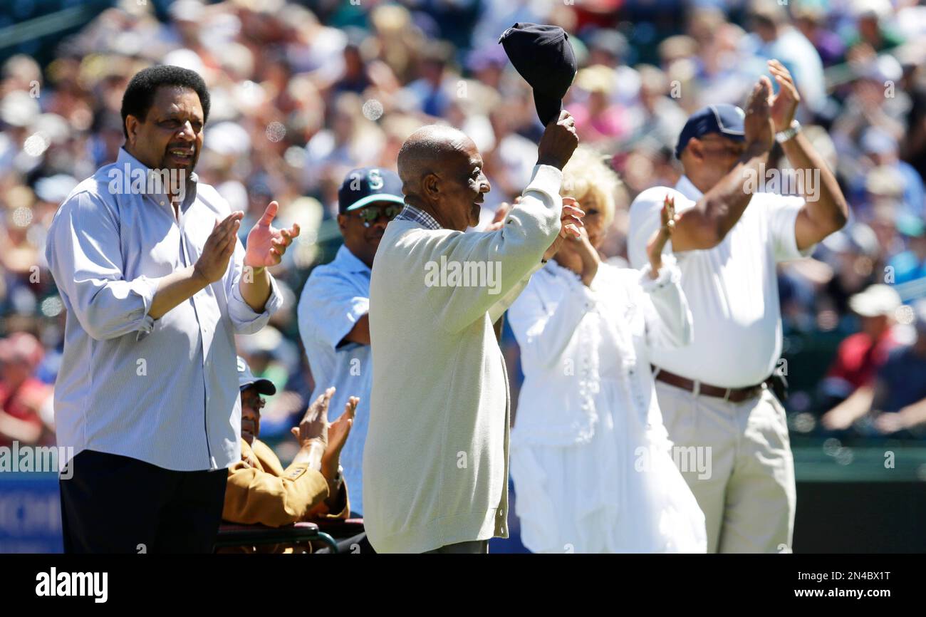 Herb Simpson, center, who played for the Seattle Steelheads Negro League baseball team, tips his ...