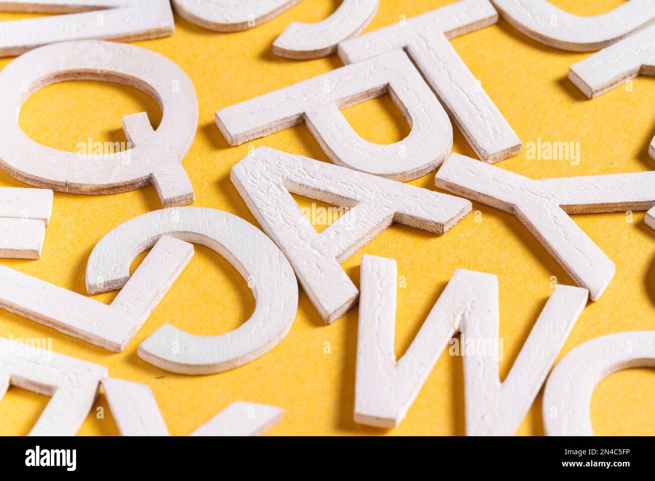 Set of letters of the alphabet in disorder, on yellow background, top ...