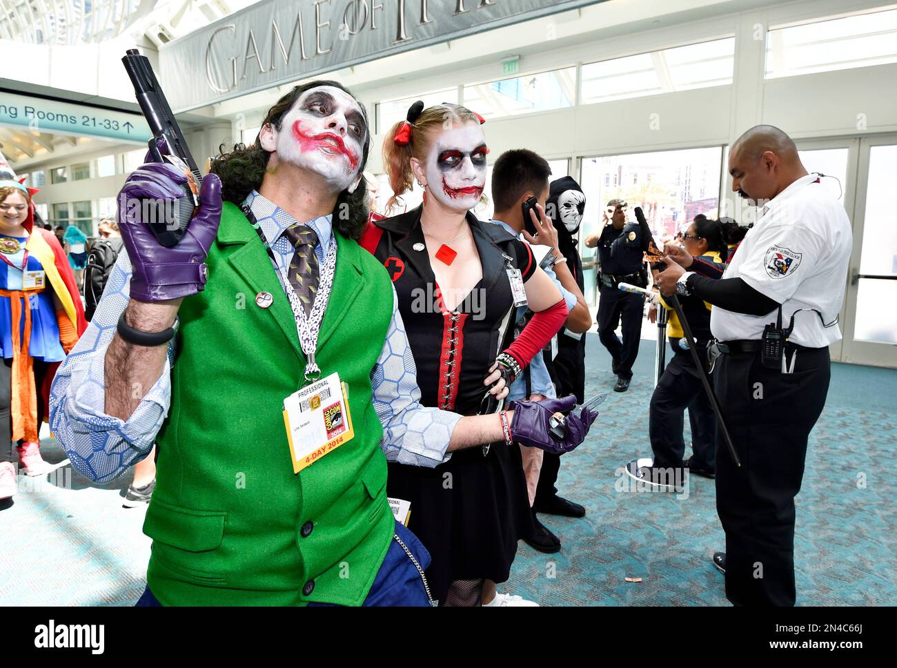 Costumed characters wait in line at a weapons check area on Day 3 at ...