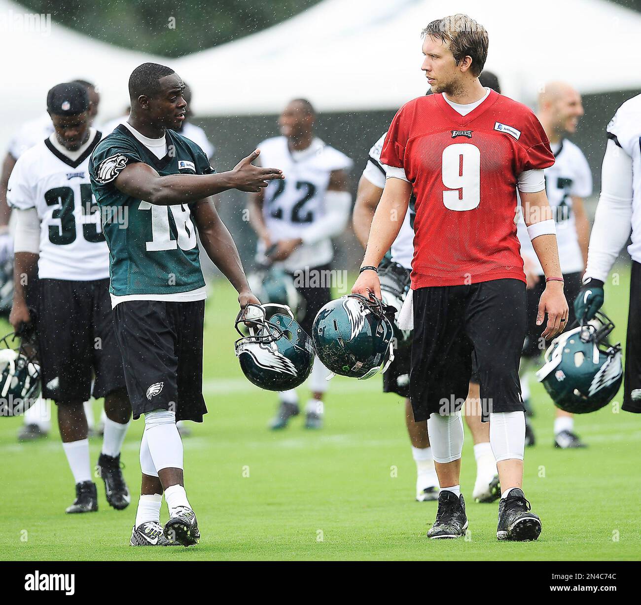 Philadelphia Eagles' Nick Foles (9) walks off the field with Jeremy ...