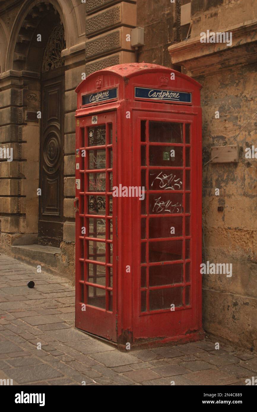 Red, English Phonebooth with grafiti on it, located on the island of ...