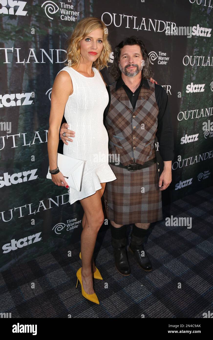 Tricia Helfer, left, and executive producer Ronald D. Moore arrive at ...