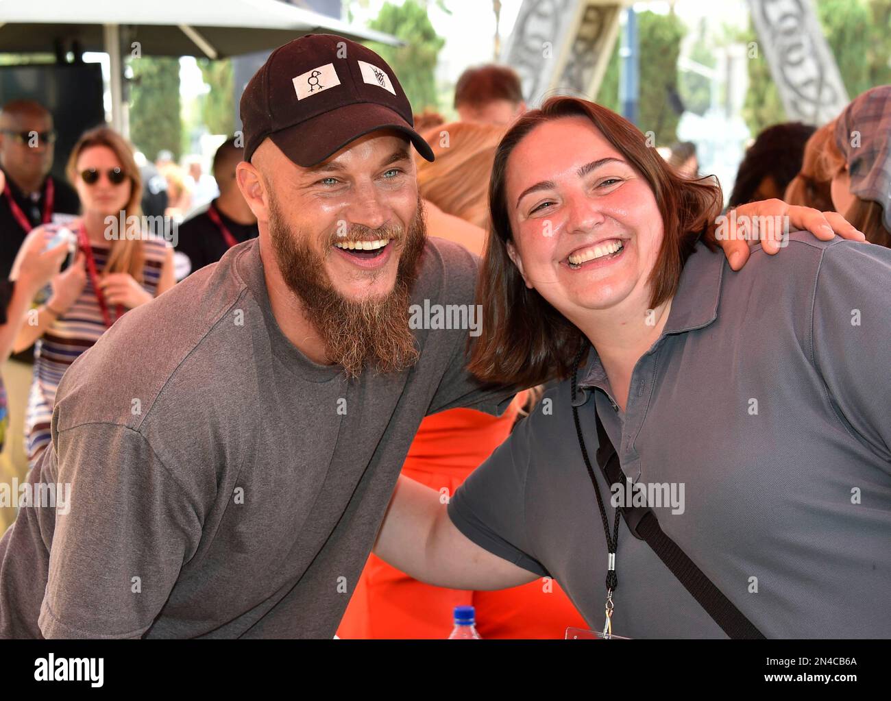 VIKINGS actor Travis Fimmel, left, poses for a photo with a fan at ...