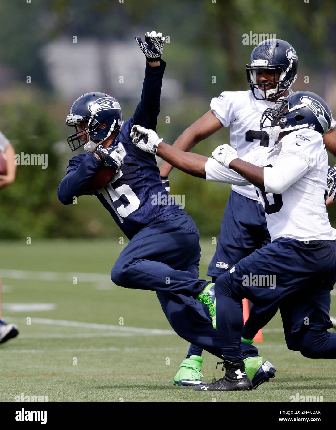 Seattle Seahawks' Jermaine Kearse, left, runs past defenders Kevin ...