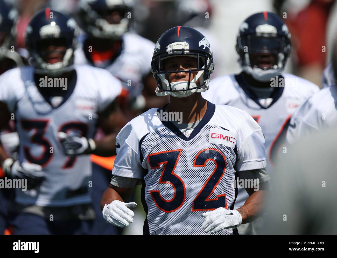 Denver Broncos cornerback Tony Carter leads his teammates on to field ...
